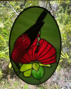 ʻApapane, stained glass by Claudia McCall - Volcano Art Center
